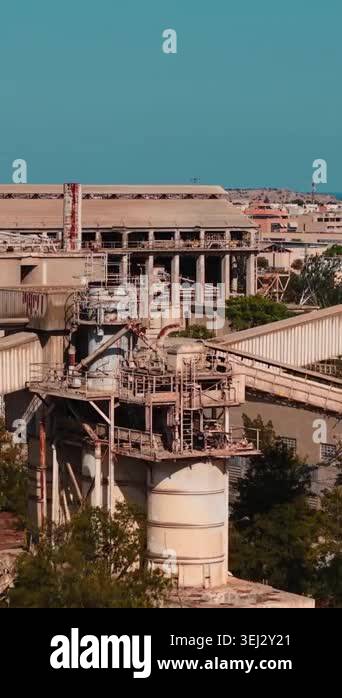Aerial view of a desolate, old industrial cement plant with rusty ...