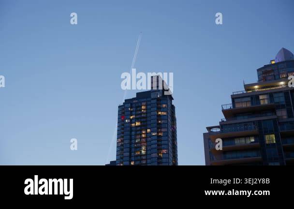 Commercial passenger airplane flying high above residential ...