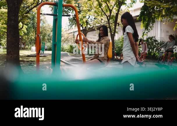 Asian mother and daughter having fun while working out together on ...