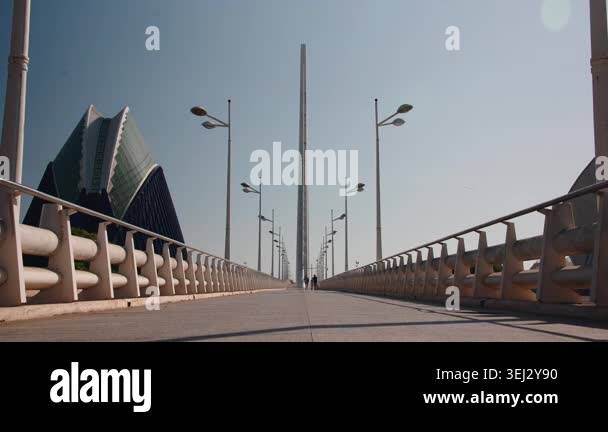 People walking on the modern assut de lor bridge in valencia with clear ...