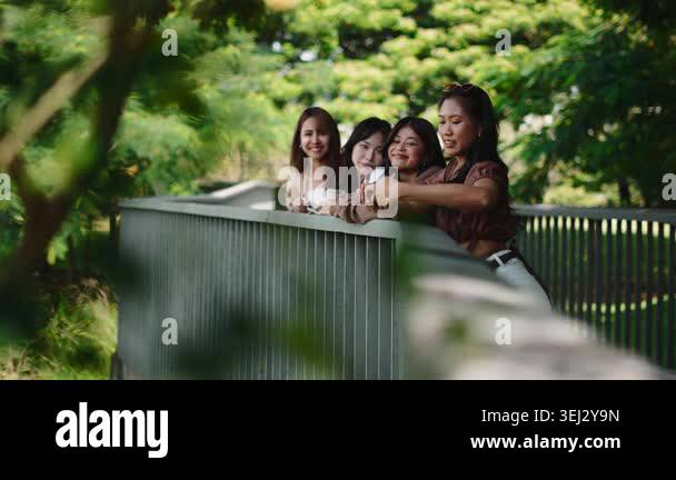 Young asian friends creating social media content together with a ...