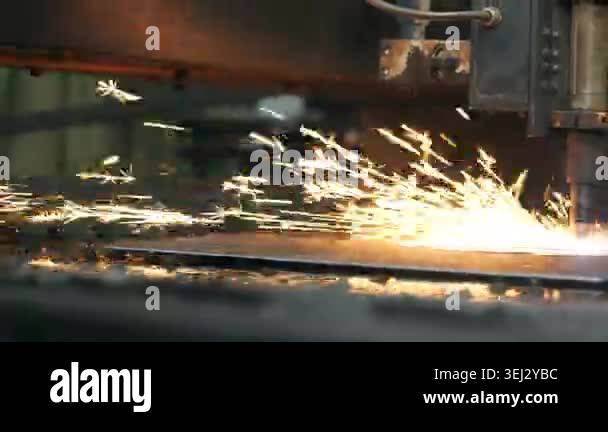 Industrial CNC plasma cutting machine cutting metal sheet with bright ...