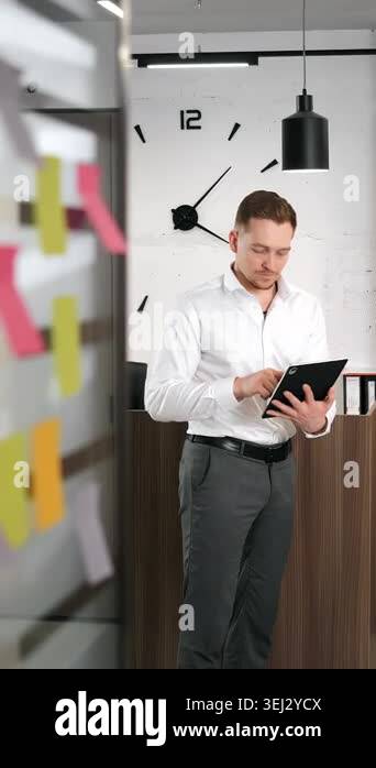 Young businessman using tablet in modern office, concept of business ...