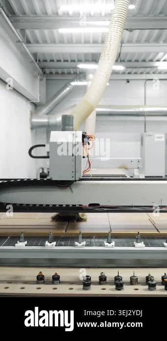CNC machine milling wood panel in factory, automated woodworking ...