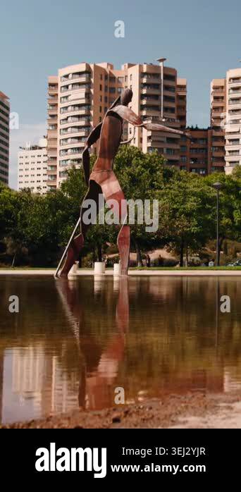 Modern metal art installation of a walking figure standing in a ...