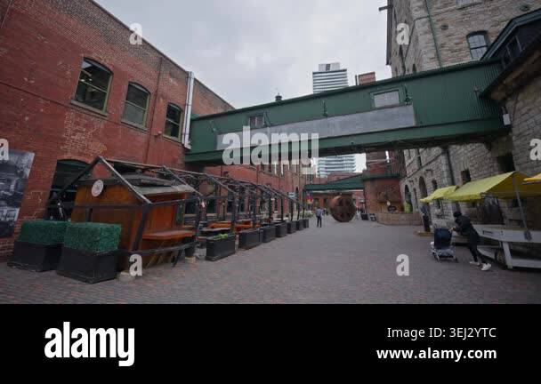 People walking through historic Distillery District in Toronto with ...