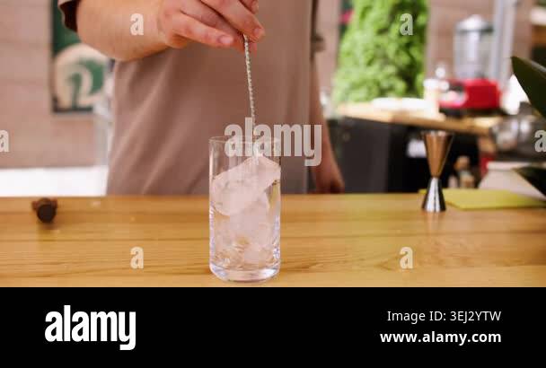 Stirring ice. Refreshing drink. Unrecognizable bartender man hand ...