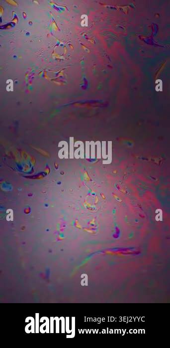Vertical video. Defocused droplet texture. Gasoline leak. Pink orange ...