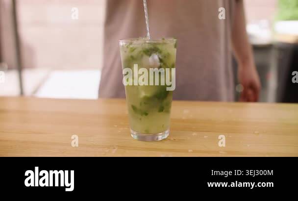 Stirring mojito. Refreshing drink. Unrecognizable bartender hand ...