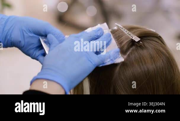 Hair foiling. Hairdresser working. Professional female master hands in ...