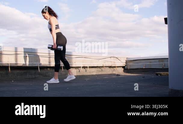 Dumbbell workout. Fitness training. Professional powerful woman athlete ...