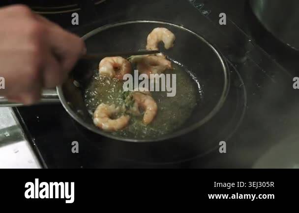 Frying shrimp. Hot seafood. Chef putting marinated peeled prawn on ...
