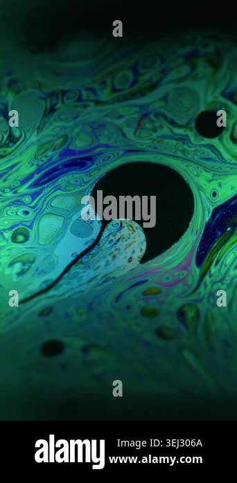 Vertical video. Defocused psychedelic texture. Circling fluid. Green ...