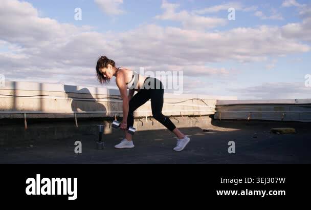 Athletic strength. Outdoor training. Active motivated woman practicing ...