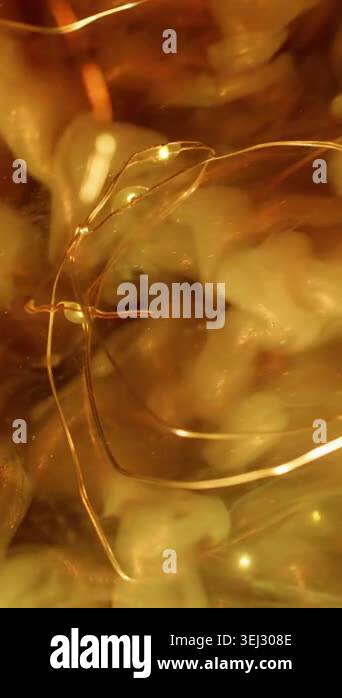 Vertical video. Paint drop. Light texture. Defocused golden yellow ...