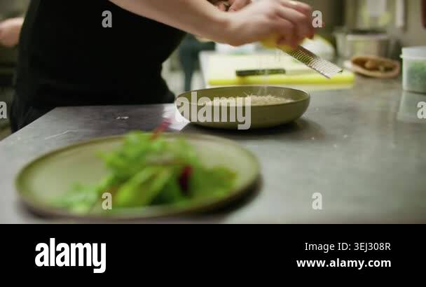 Shredding cheese. Food preparation. Unrecognizable professional chef ...