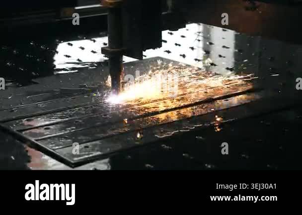 Industrial CNC plasma cutting machine cutting metal sheet with bright ...