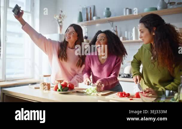 Happy women cooking kitchen together posing smartphone photo. Smiling ...