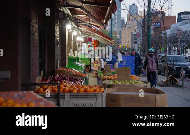 Outdoor urban fruit market bustling on a Toronto sidewalk as customers ...