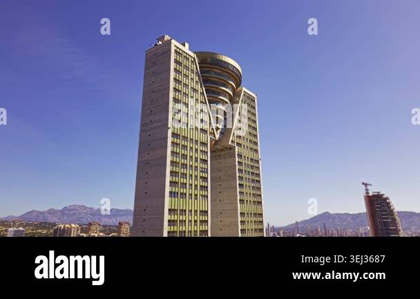 Modern skyscraper architecture with unique design against clear blue ...