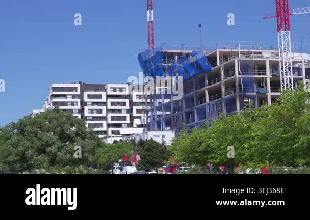 Modern residential building under construction with tower crane and ...