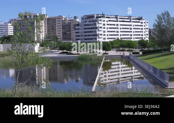 Modern residential apartment buildings reflected in calm water of ...