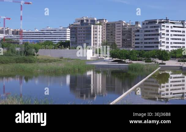 Modern residential apartment buildings reflected in calm water of urban ...