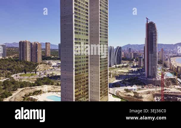 Modern skyscraper architecture with unique design against clear blue ...