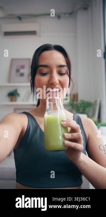 Video of itness woman drinking a healthy green juice while taking a ...