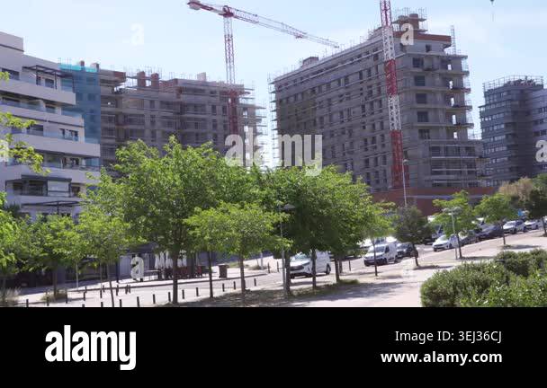 Modern residential buildings under construction with tower cranes and ...
