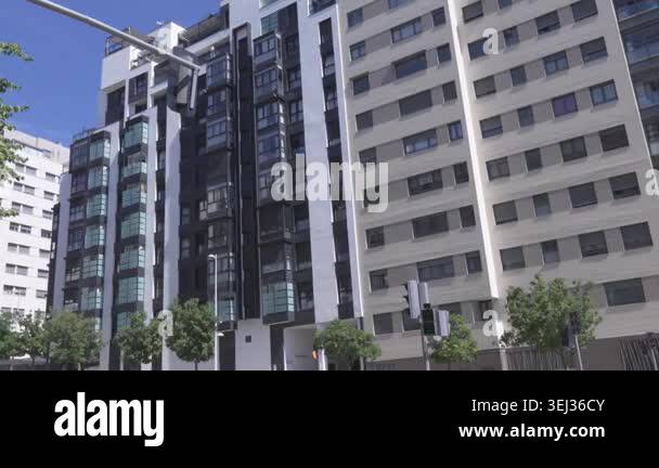 Modern residential apartment complex with balconies and large windows ...
