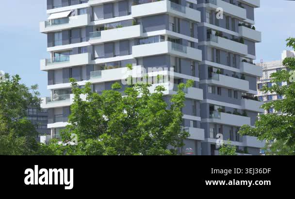 Modern residential apartment building with white layered balconies in ...
