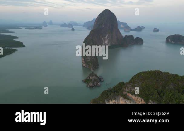 Aerial footage flying over the limestone karsts and emerald waters of ...