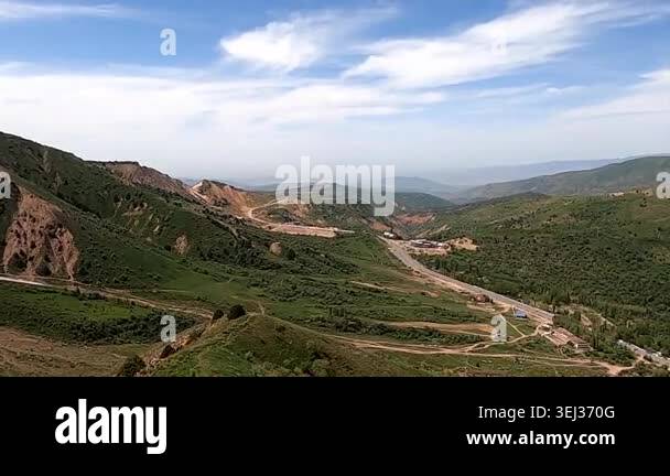 Scenic cinematic panning shot of the Chimgan Mountains in Uzbekistan ...