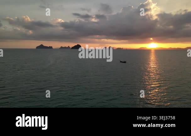 Majestic aerial view of a dramatic sunset over a calm sea, with the sun ...