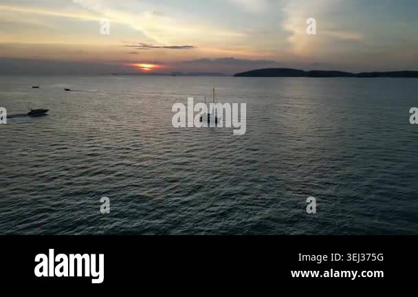 Aerial view of a sailboat floating on the calm sea in Ao Nang, Krabi ...
