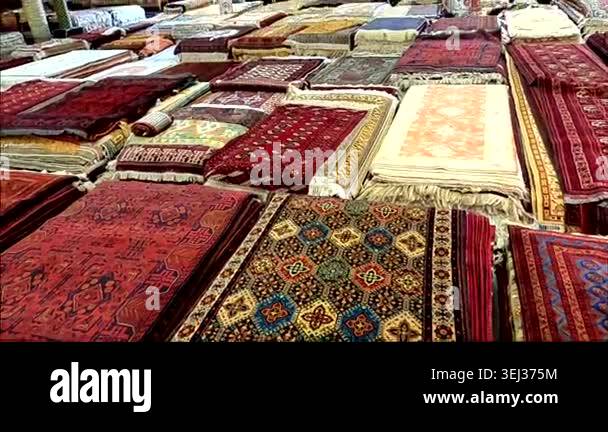 Cinematic panning shot inside traditional carpet workshop in Bukhara ...