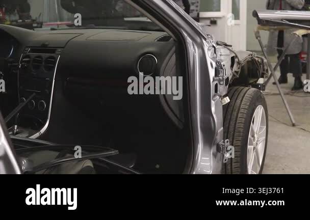 Car undergoing body repair in a modern auto repair shop during ...