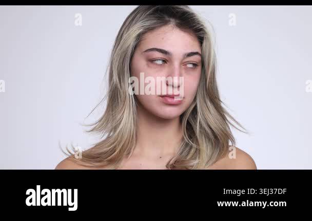 4K video portrait of young woman looking aside then giving subtle smile ...