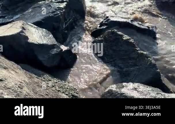 High Angle View of Sparkling Sunlit Muddy Stream Flowing and Swirling ...