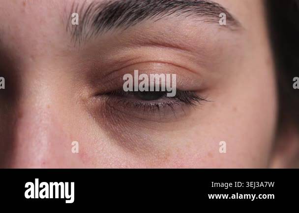 4K video macro closeup of young woman opening eye and closing it, no ...