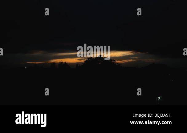 Dramatic Dark Sunset Sky with Last Golden Light Peeking Behind Heavy ...
