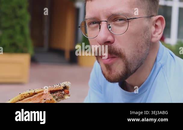 A happy man eats street food Stock Video Footage - Alamy