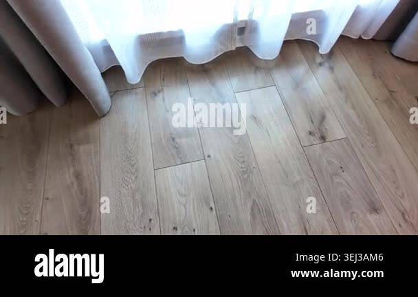 Natural wood laminate parquet floor. Room with laminate in new apartmen ...