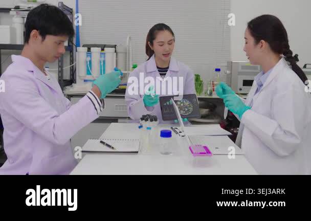 Female and male scientists work in labs and analyze samples in research ...