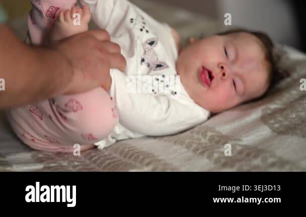 Close up of a baby lying on a soft surface, looking calm and curious ...