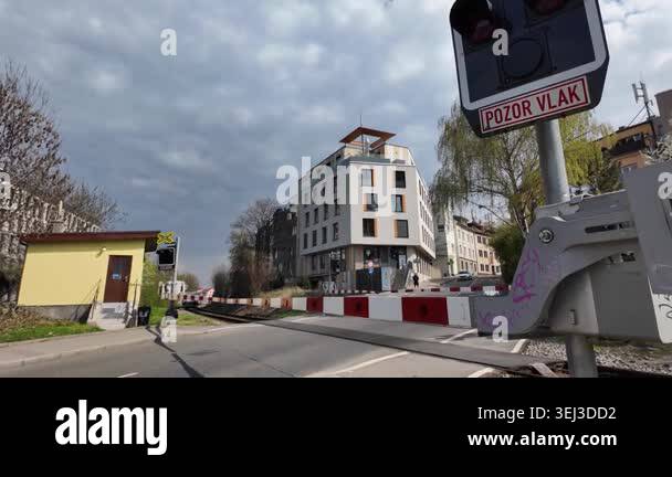 Prague, Czech Republic - April 16, 2026 - Train crossing barrier lowers ...