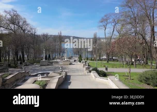 Wide scenic view of a landscaped lakeside park with stone stairways ...