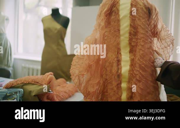 Translucent orange organza garment with raised wavy stitched details ...