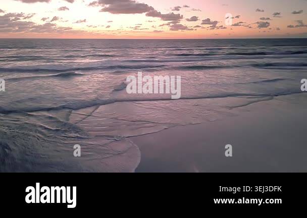Remote sandy beach and ocean waves during sunrise on Fraser Island ...